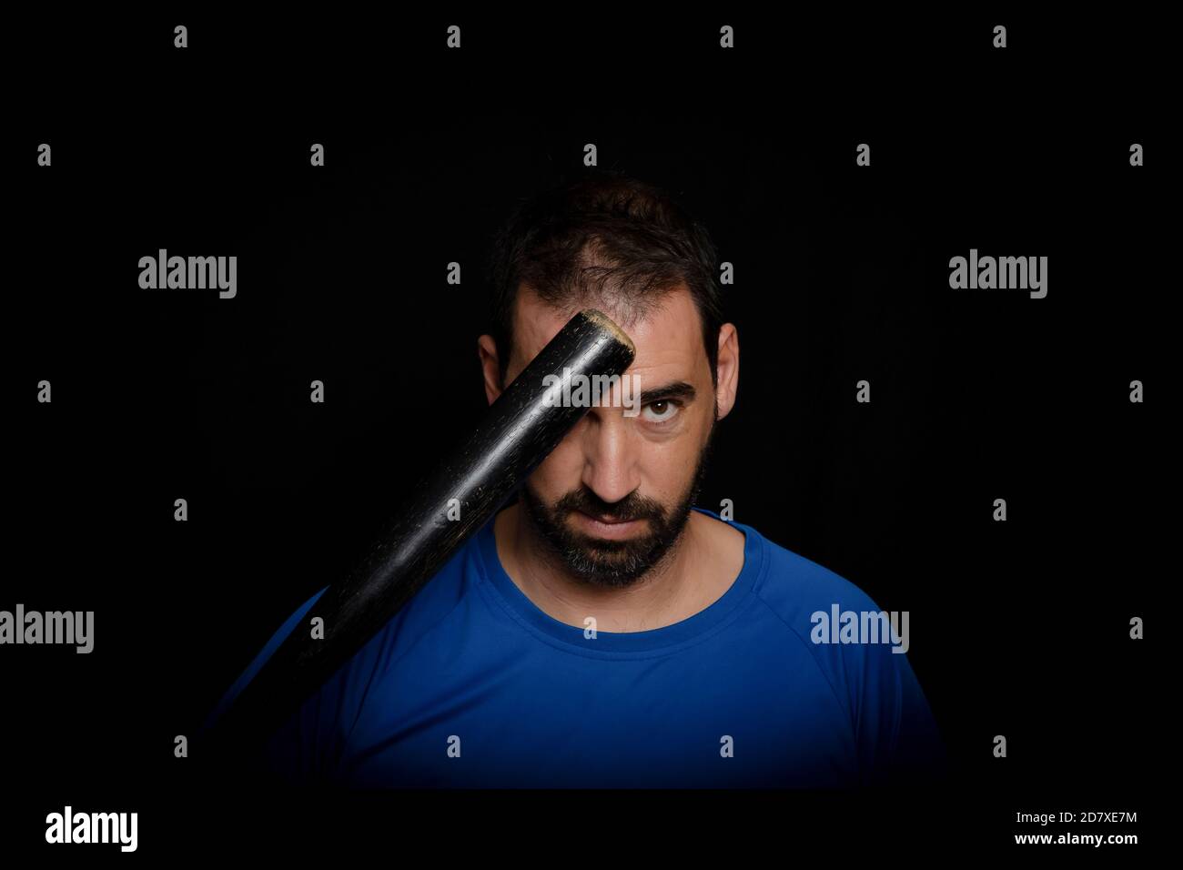 Bearded man dressed in blue t-shirt in defiant pose posing with a ...