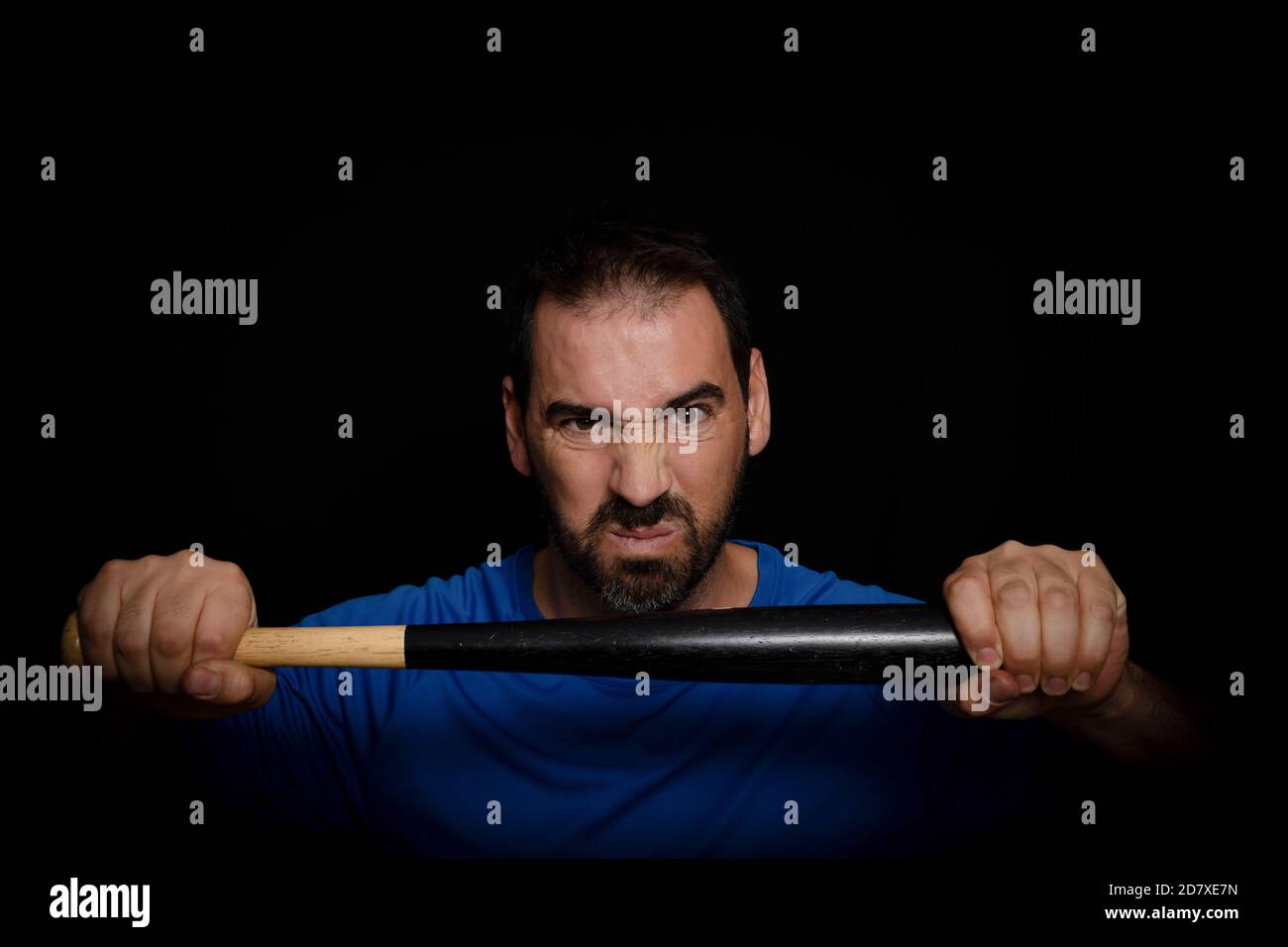 Bearded man dressed in blue t-shirt in defiant pose posing with a ...