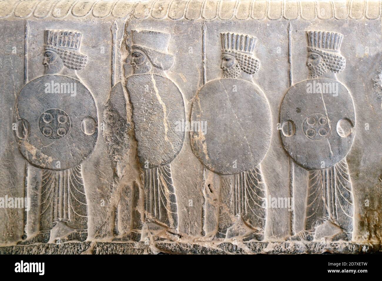 Ancient Wall With Bas Relief With Assyrian Warriors With With Spears And Shields Persepolis