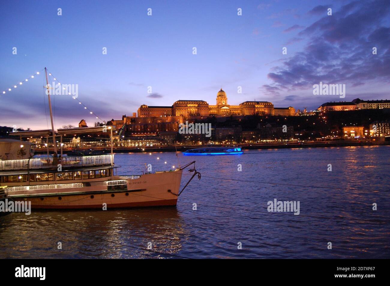 Danube river in Budapest in a romantic evening with blue light cruising ...