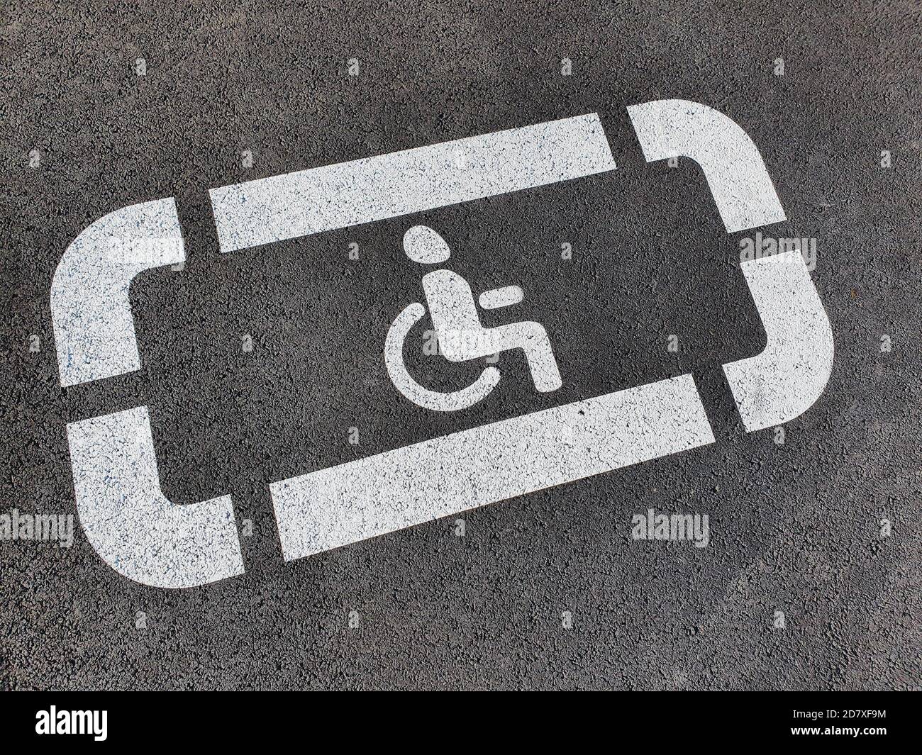 New disabled person sign painted on the new asphalt. Close up view ...