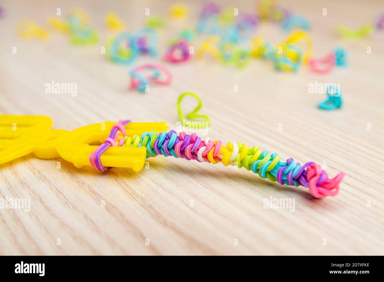 Rubber Band Weaving. Knitting rubber bands with loom knit. Hands of ...