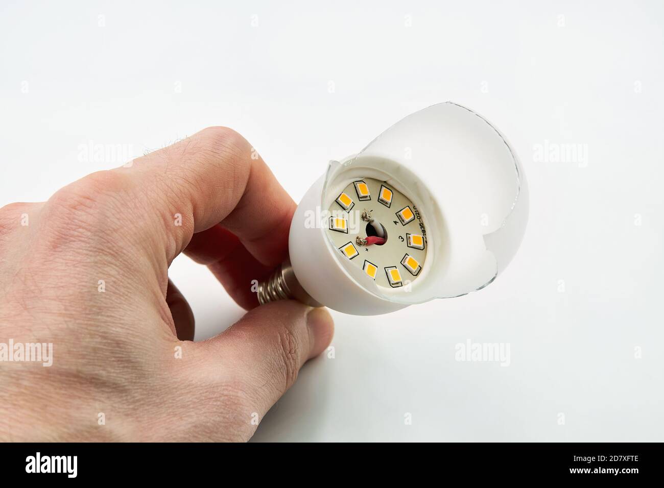 Man holds in his hand a broken led lamp on a white background Stock ...