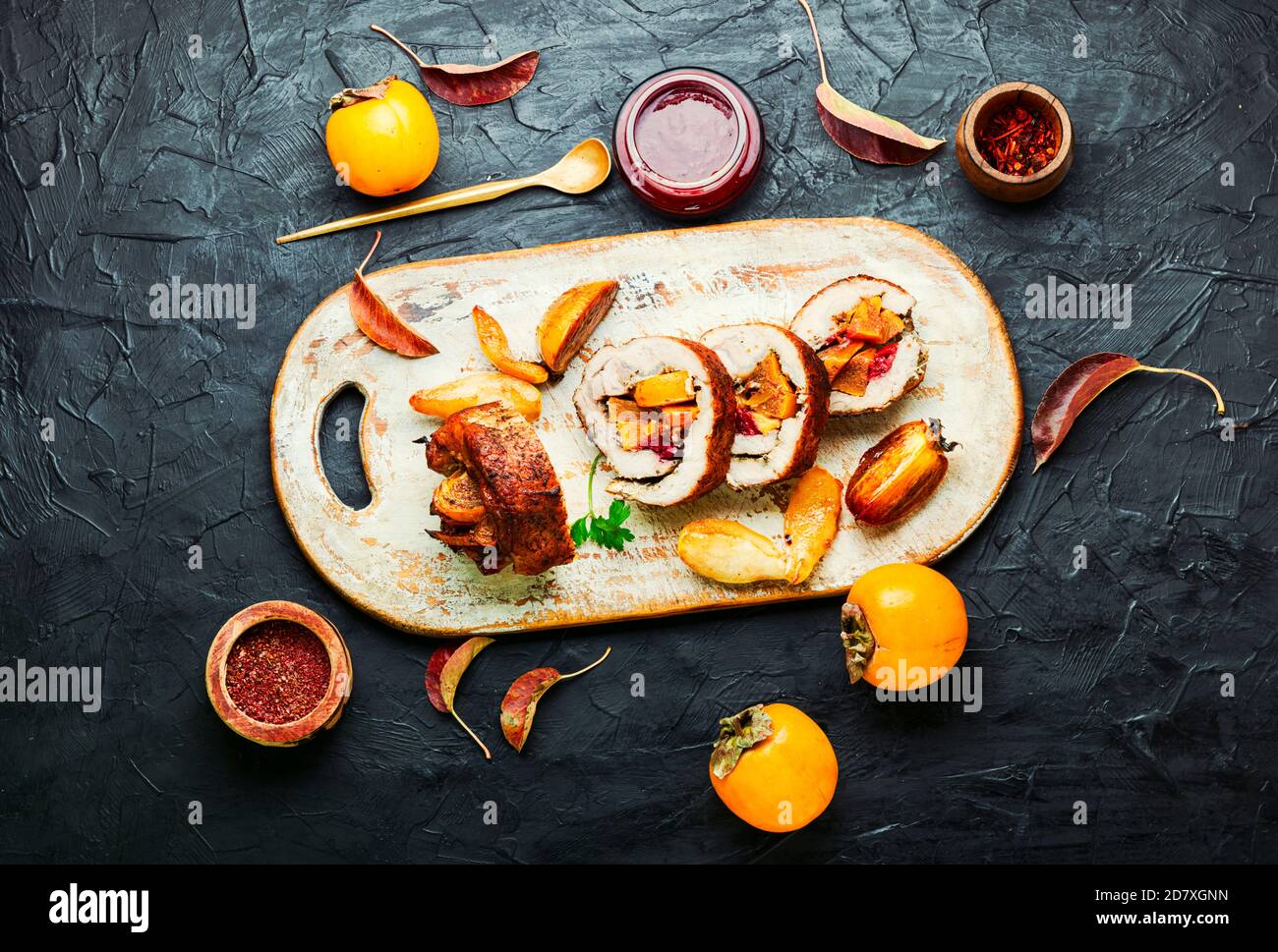 Baked pork roll with autumn persimmon.Meat stuffed with fruits.Autumn ...
