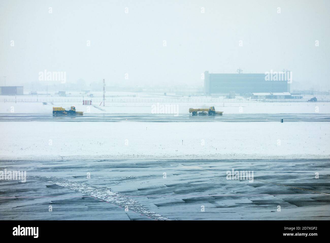 Two snow plows on the runway in a snowstorm Stock Photo - Alamy