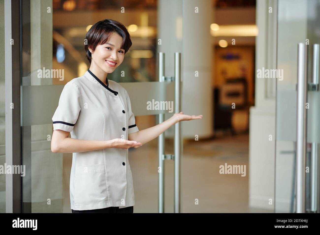 Inviting guests inside hotel Stock Photo - Alamy