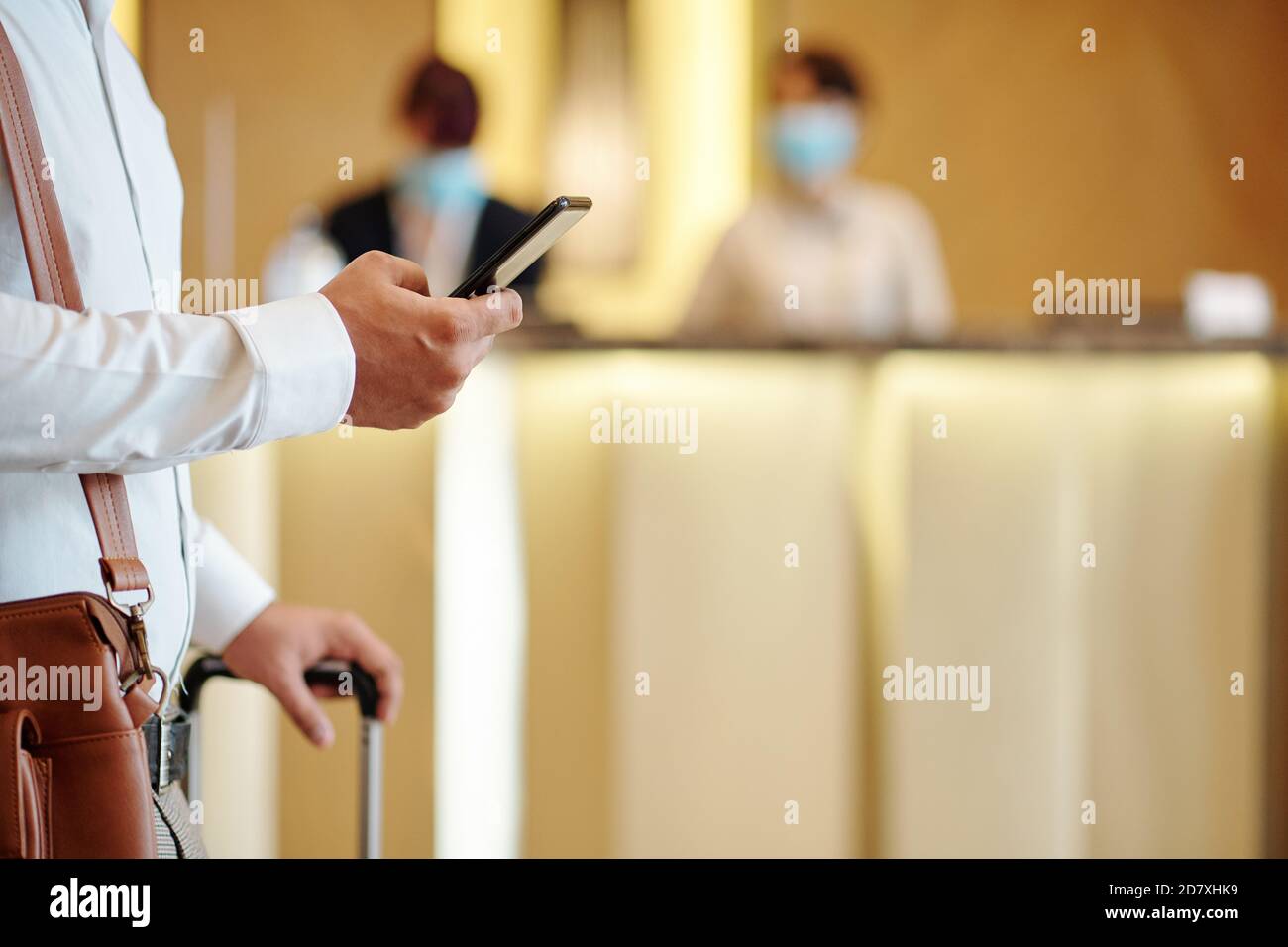 Hotel guest checking phone Stock Photo - Alamy