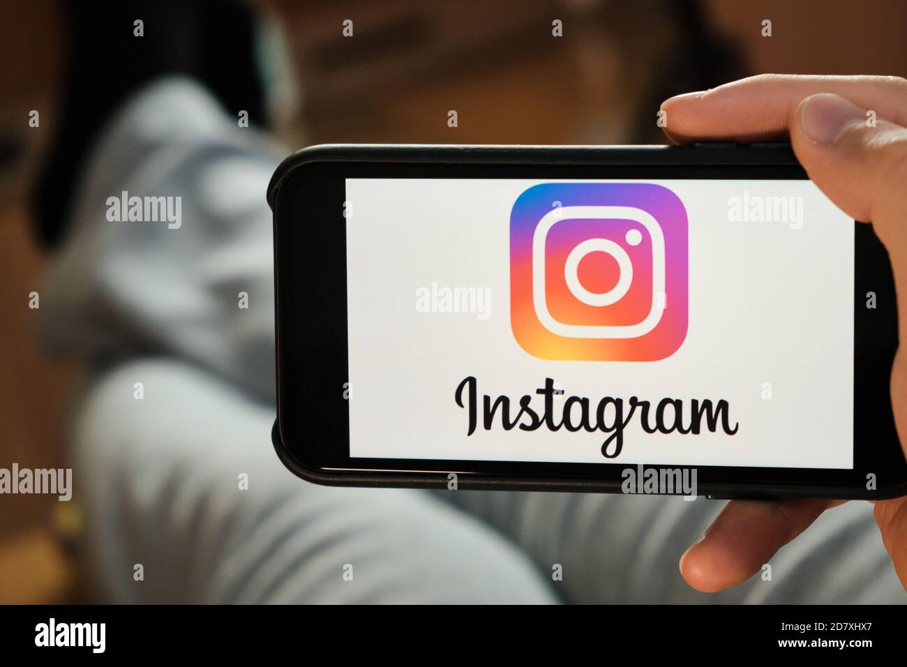Instagram logo on the screen of a mobile phone in mans hand ...