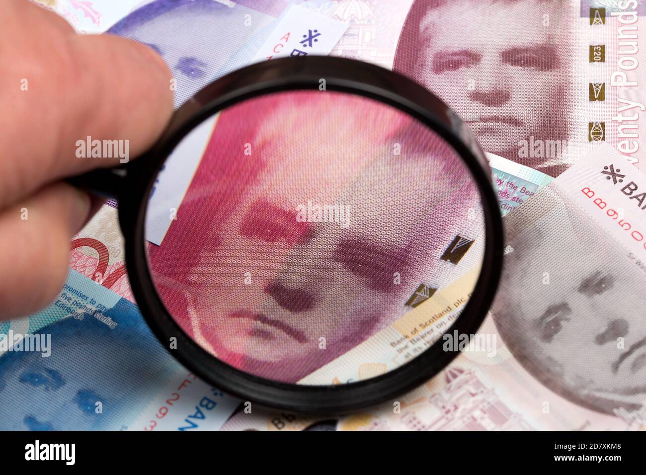 Scottish pound in a magnifying glass Stock Photo - Alamy