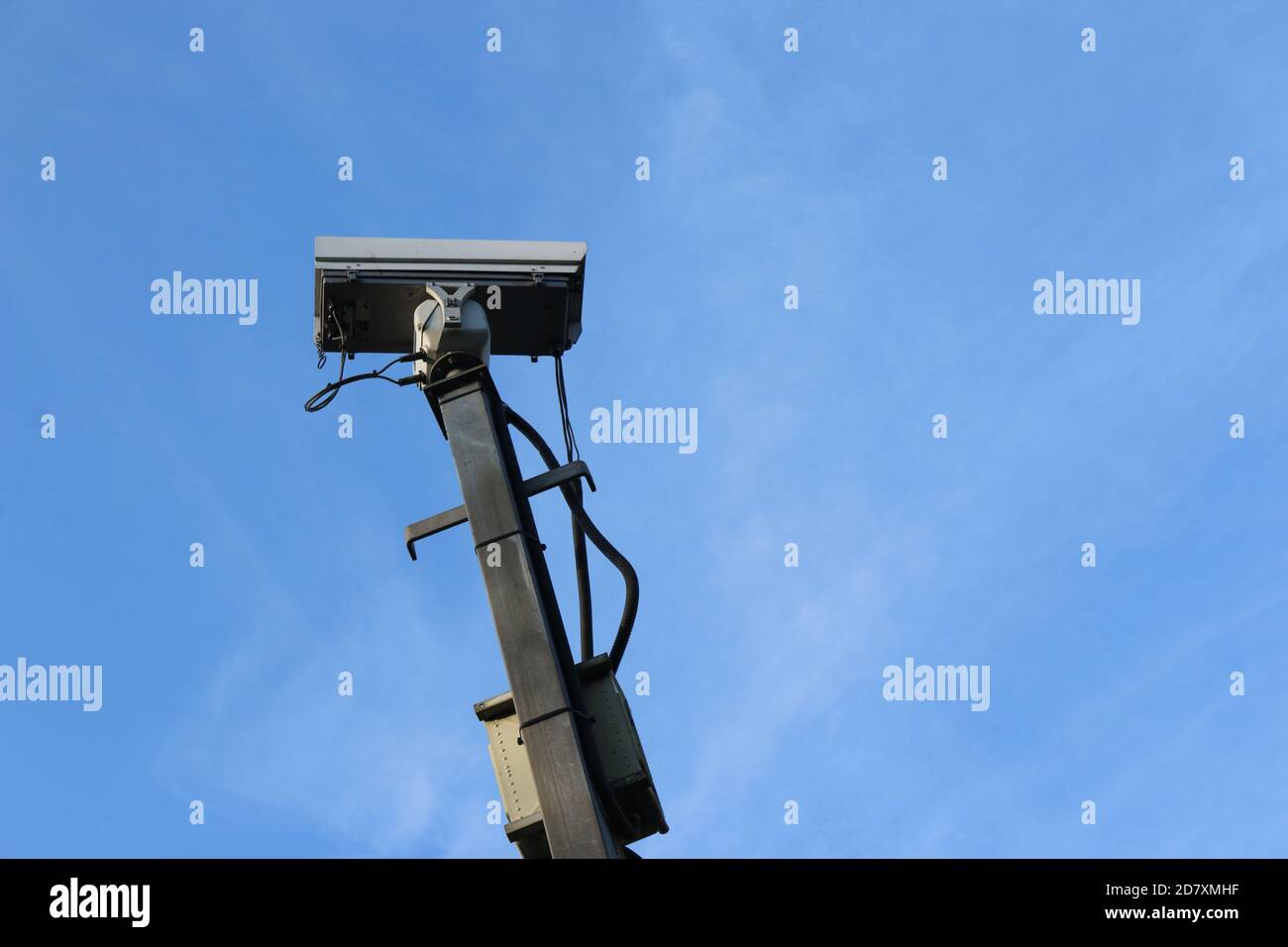 CCTV camera on metal square column with blue sky and light clouds in ...