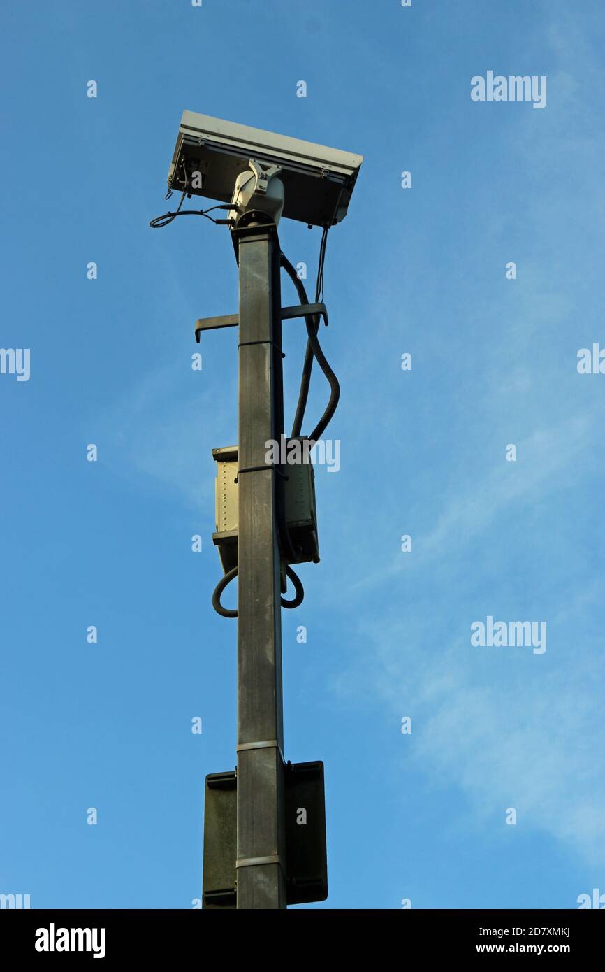 CCTV camera on metal square column with blue sky and light clouds in ...