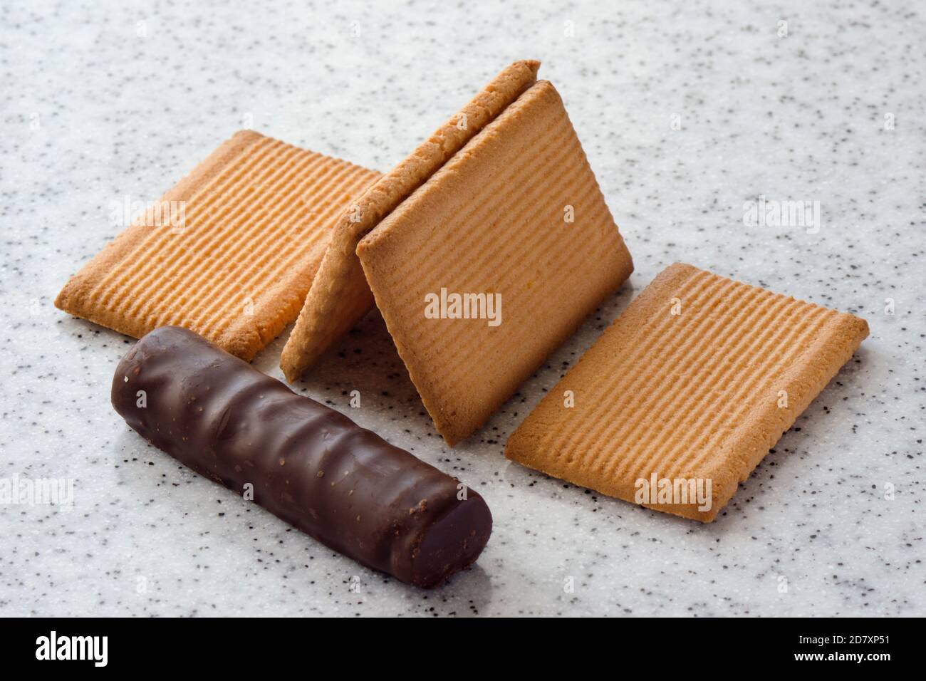 Rectangular shortbread cookies and chocolates on a light marble top ...