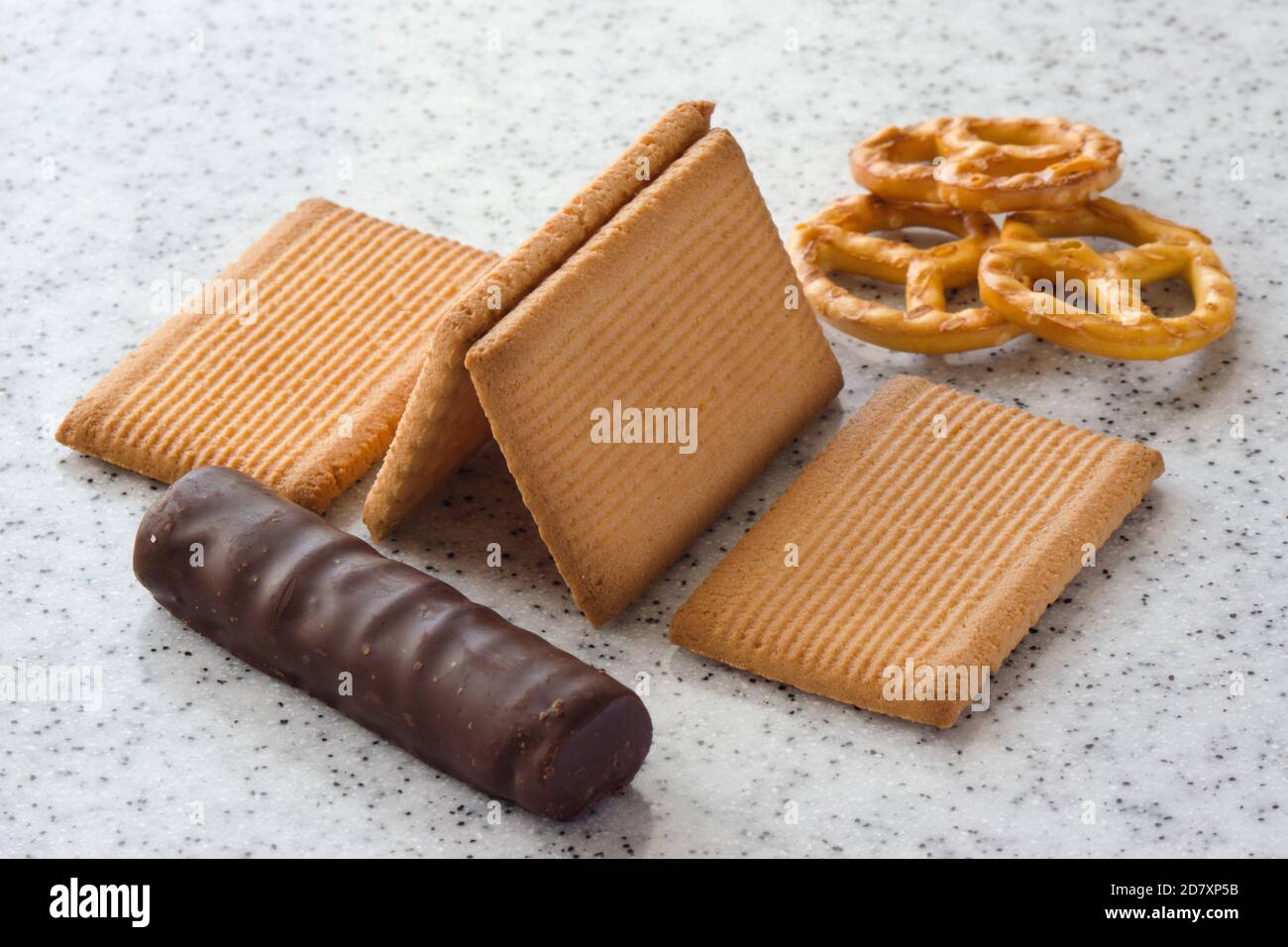 Rectangular shortbread cookies and chocolates on a light marble top ...