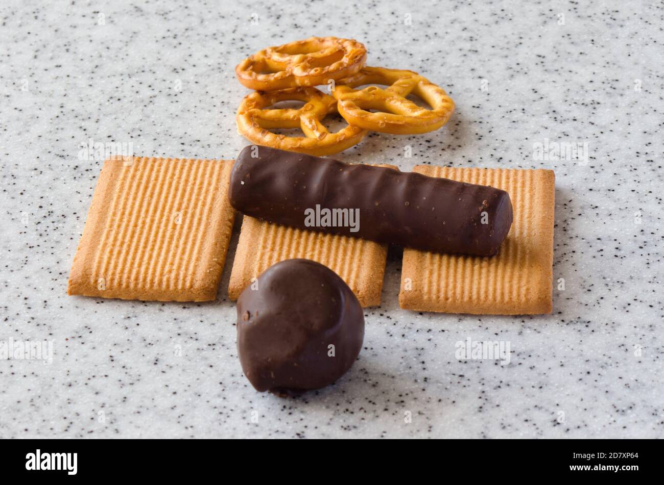 Rectangular shortbread cookies and chocolates on a light marble top ...