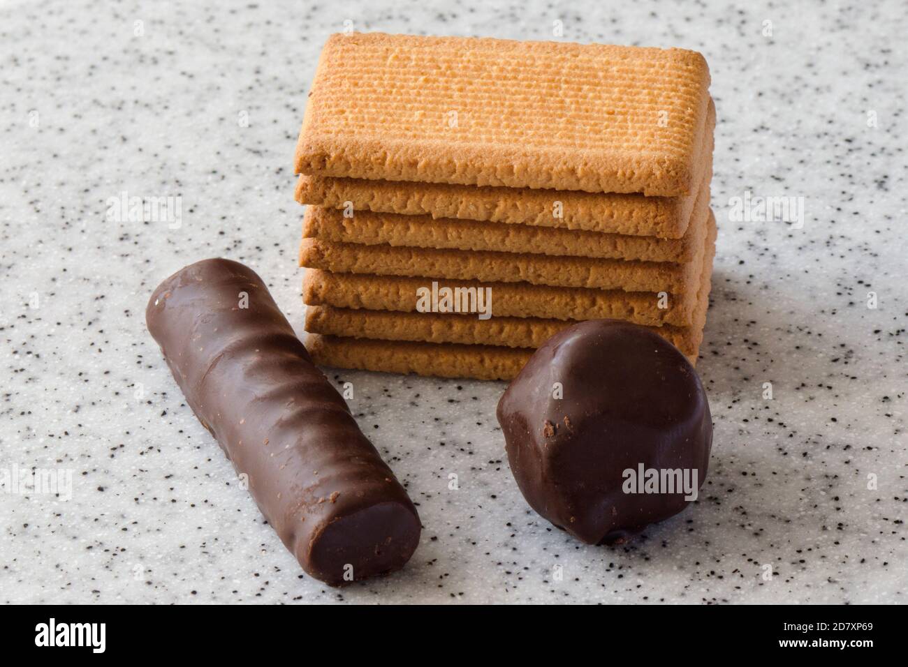 Rectangular shortbread cookies and chocolates on a light marble top ...