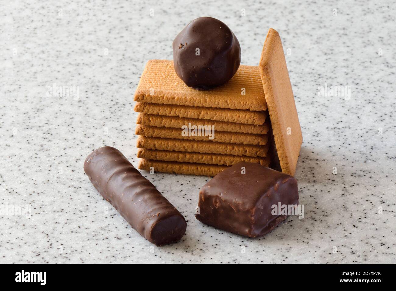 Rectangular shortbread cookies and chocolates on a light marble top ...