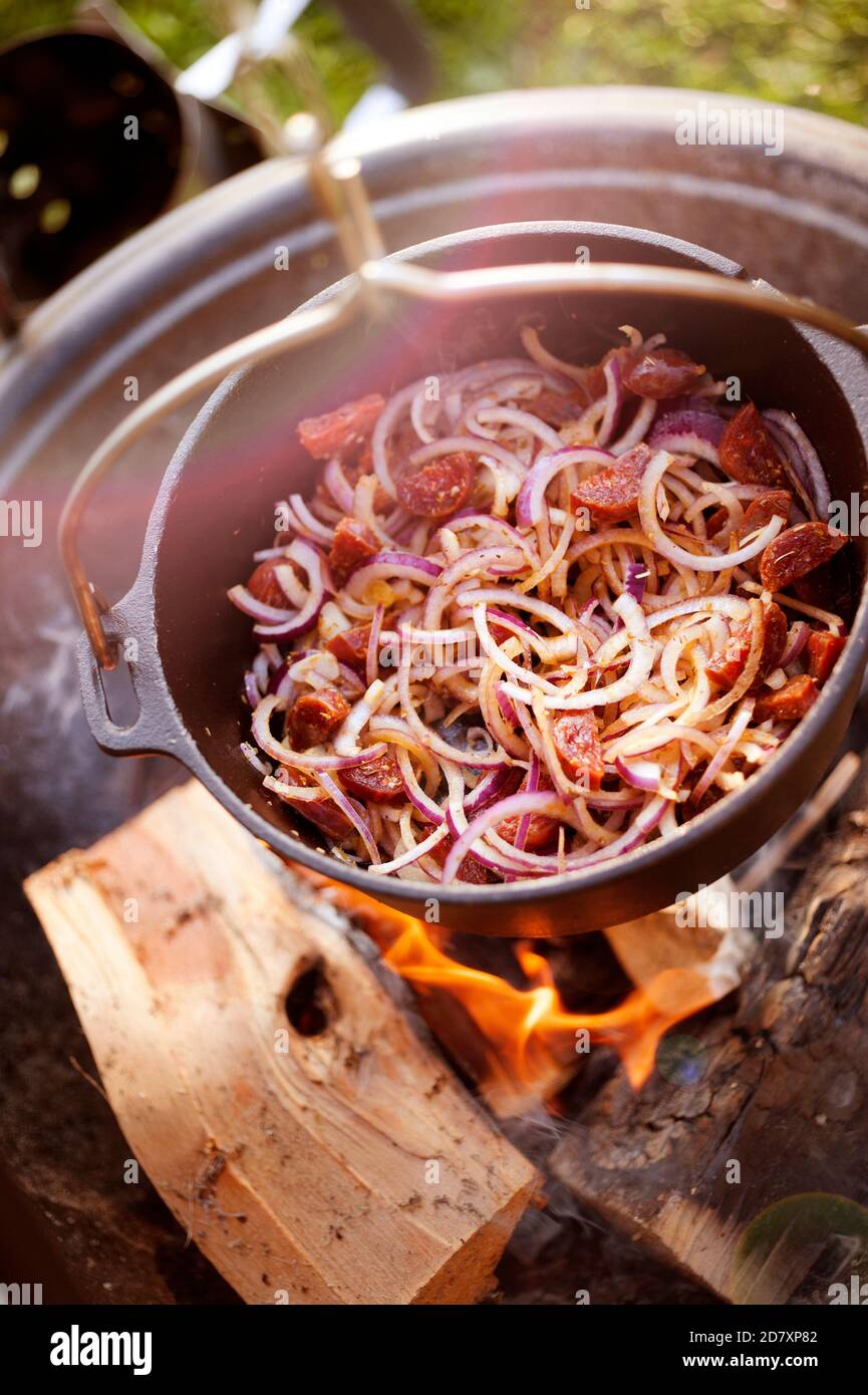 Spicy chorizo and onion stew cooking over fire pit Stock Photo - Alamy