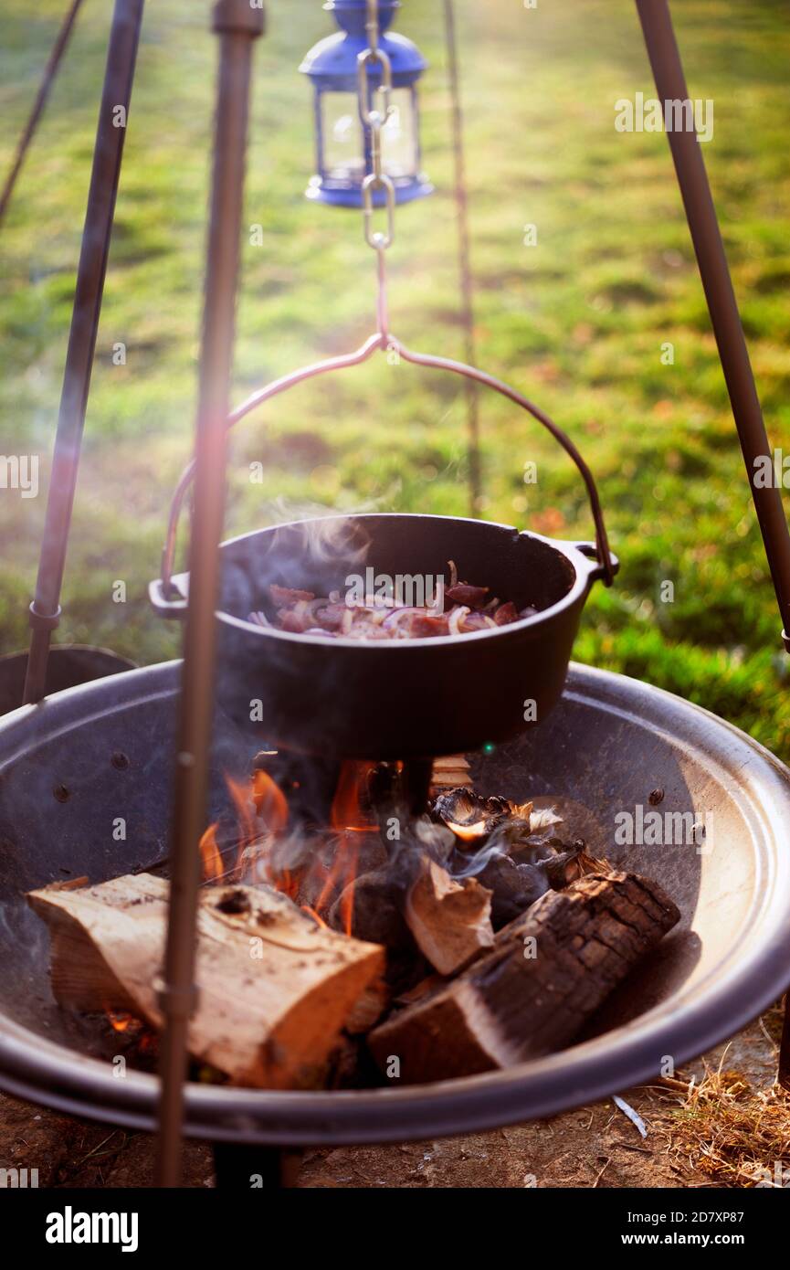 Spicy chorizo and onion stew cooking over fire pit Stock Photo - Alamy
