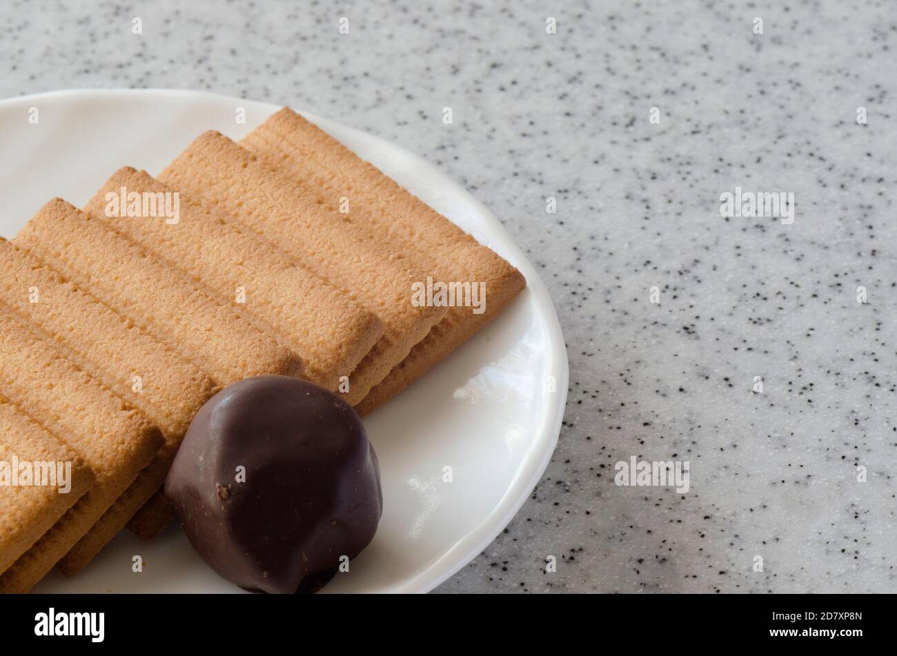 Rectangular shortbread cookies and chocolates on a white saucer Stock ...