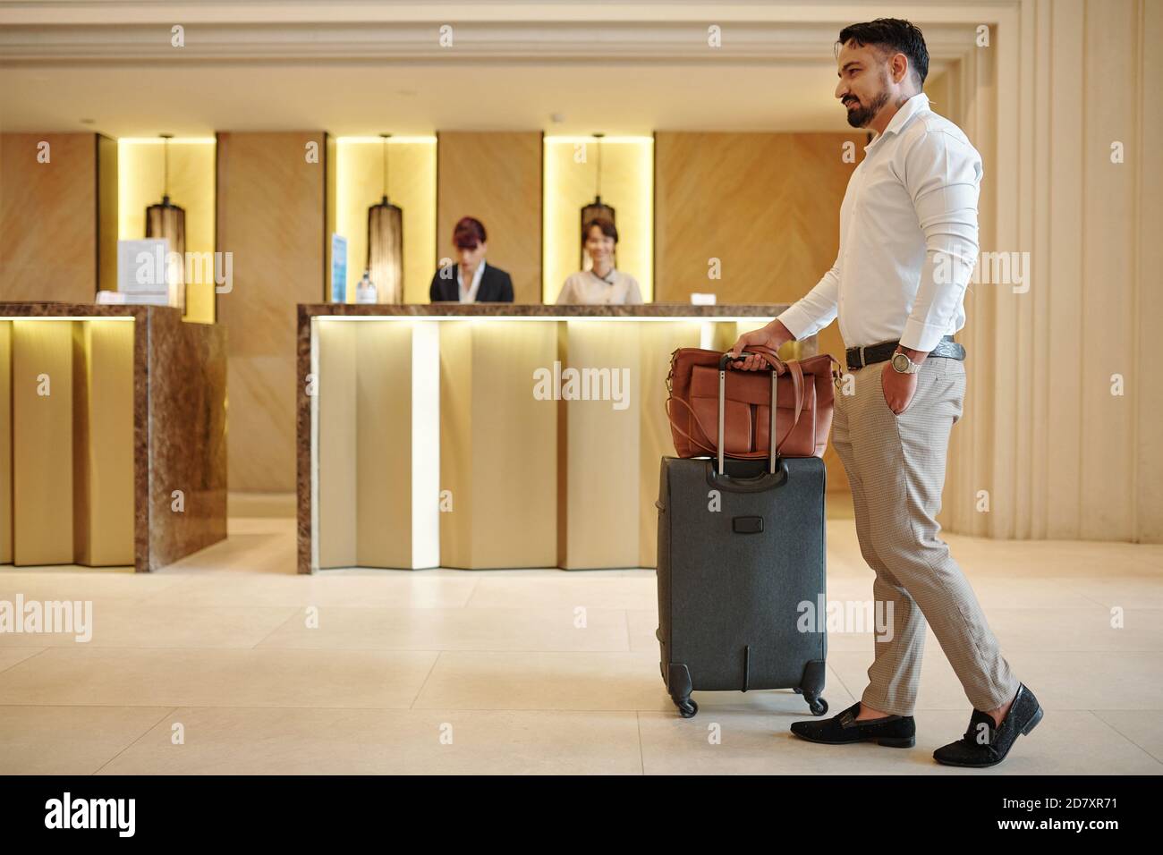 Elegant man entering hotel lobby Stock Photo - Alamy