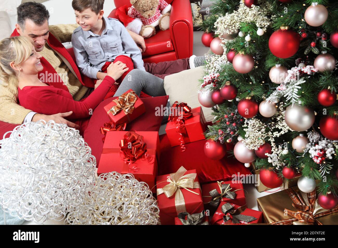 merry christmas, happy family at home near the illuminated and ...