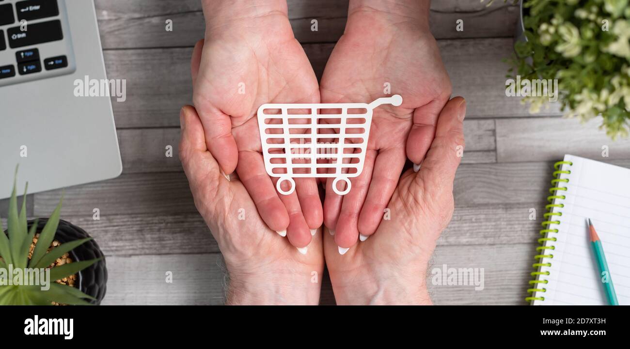 Concept of secure purchase with paper shopping cart in hands Stock ...
