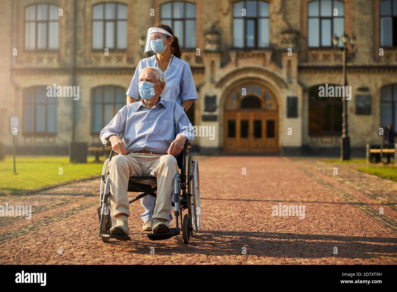 Doctor and patient wearing protection while walking Stock Photo - Alamy