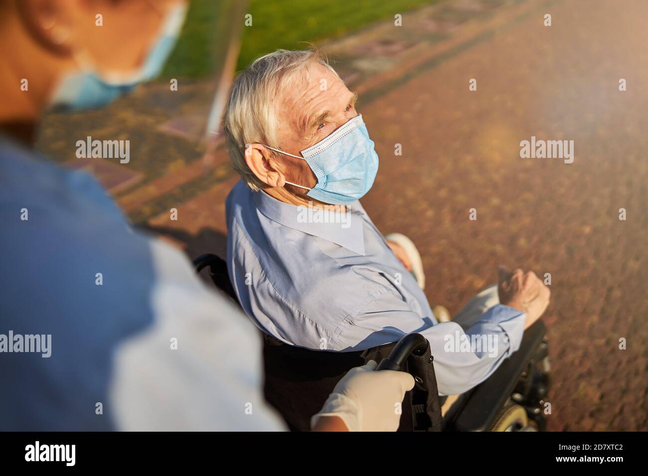 Cropped photo of a person rolling elderly in wheelchair Stock Photo - Alamy