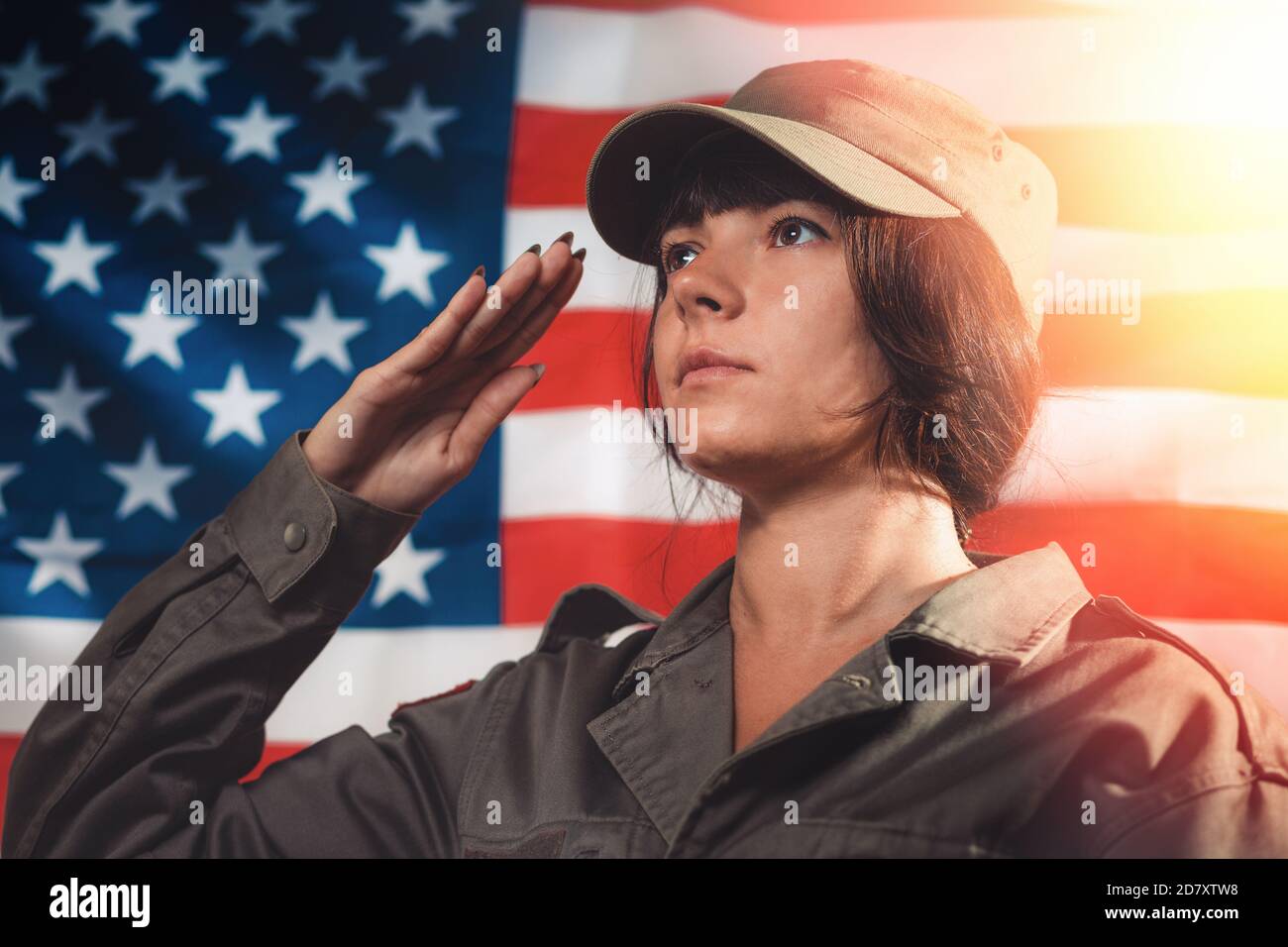 USA celebration. Portrait of a female soldier saluting, against the ...