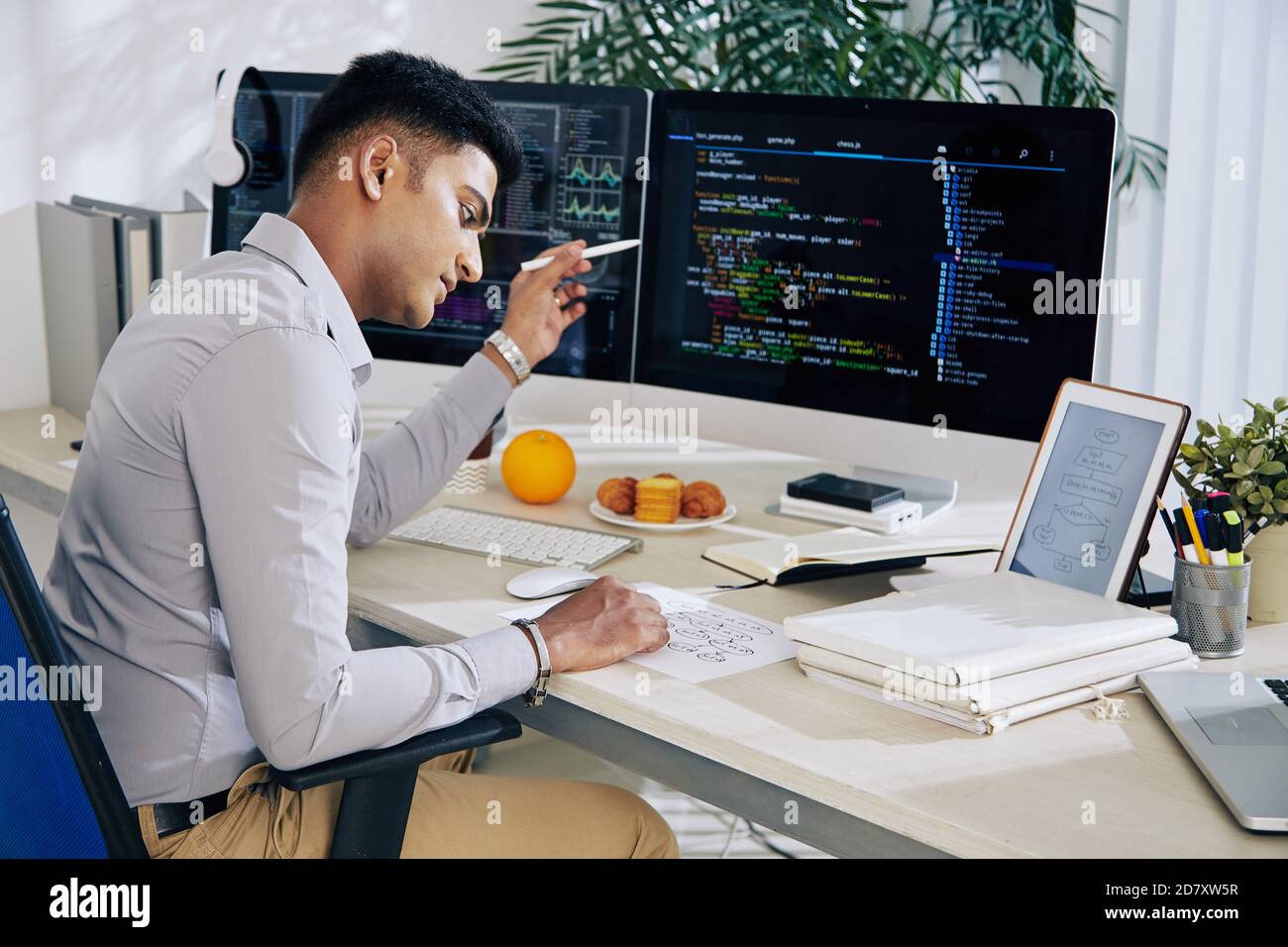 Developer checking structure chart Stock Photo - Alamy