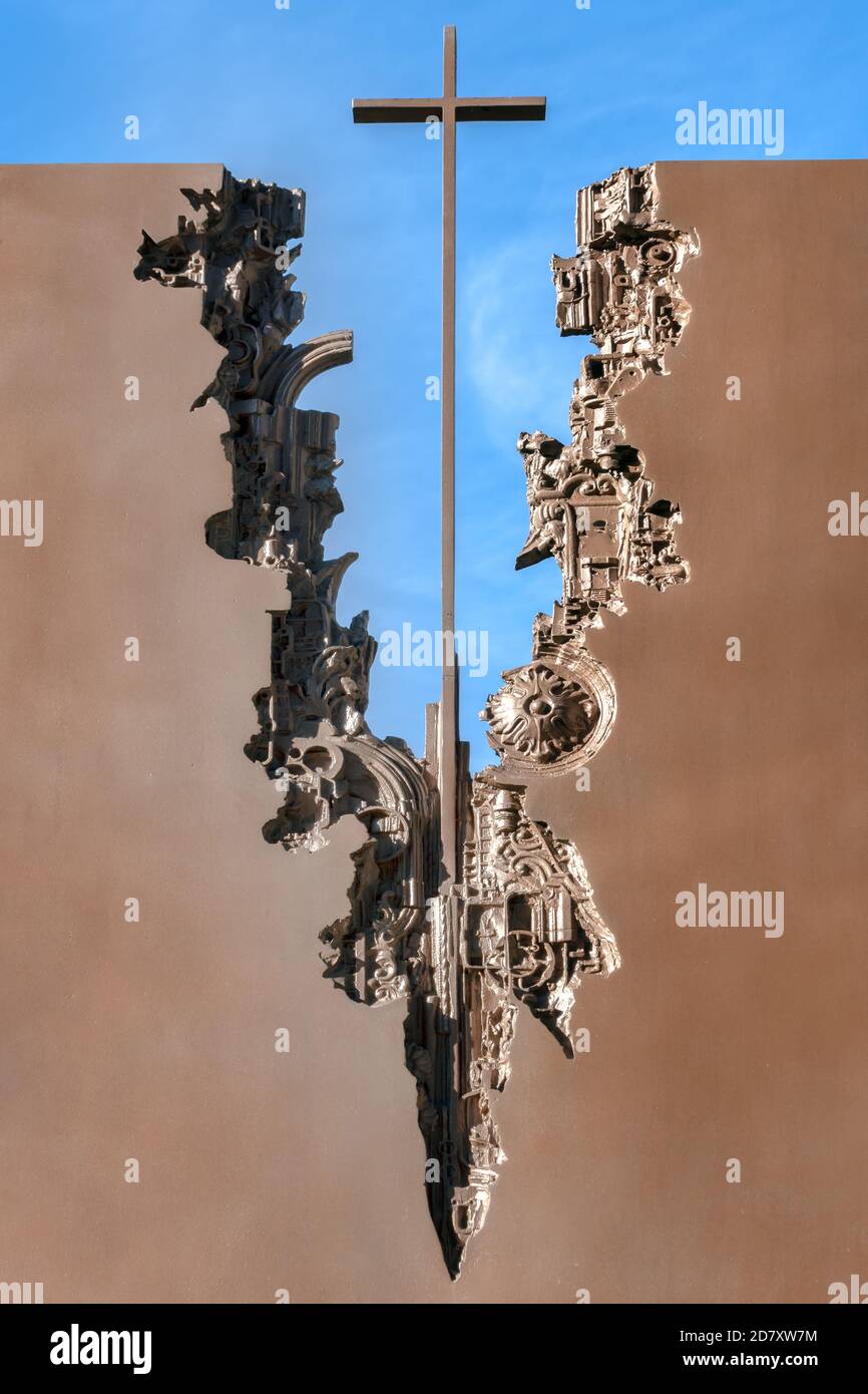 Modern sculpture of an iron cross with gears Stock Photo - Alamy