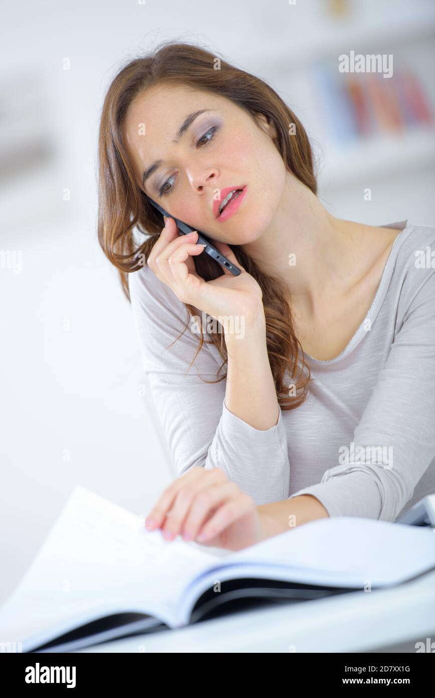 she is clarifying something on the phone Stock Photo - Alamy
