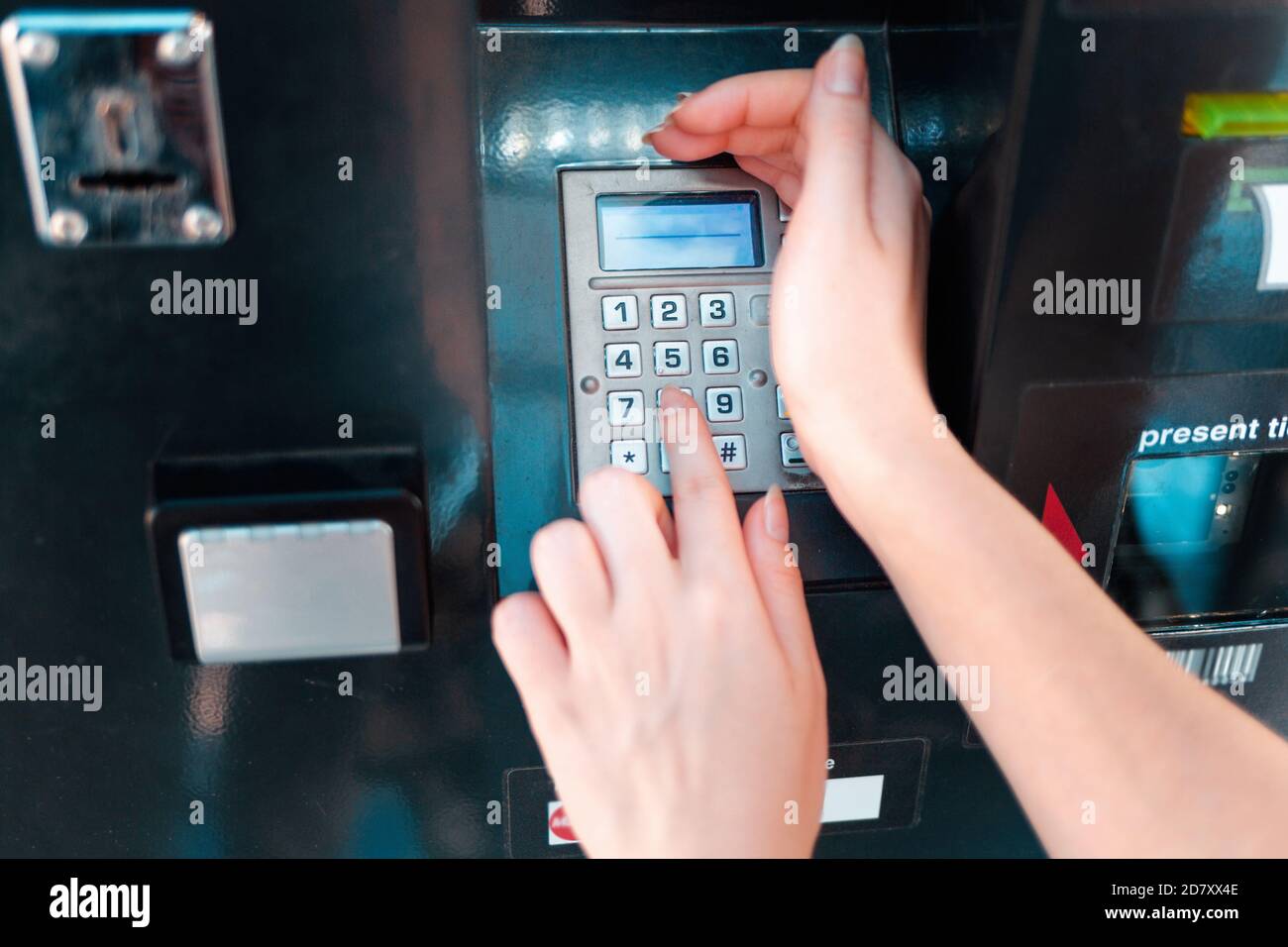 ATM and banking operations. The woman, covering his hand, enters the ...