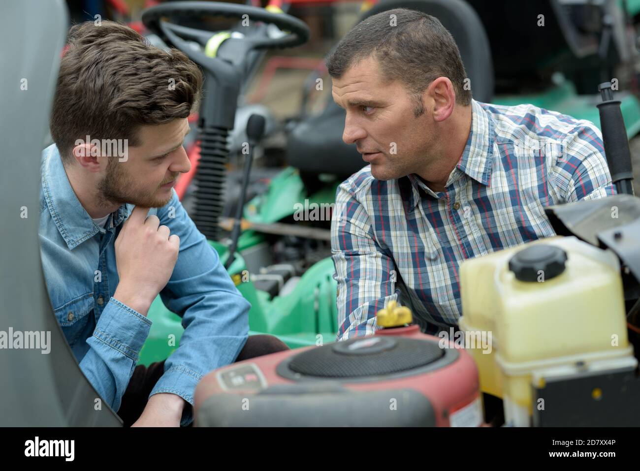 two men working in a garage Stock Photo - Alamy