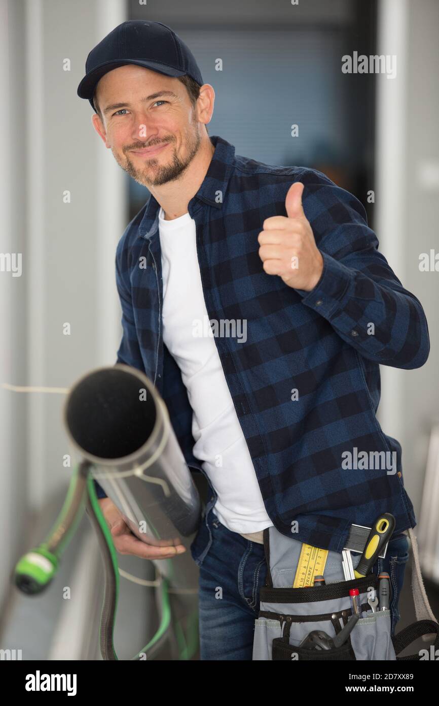 worker with gripper in hand is fixing a pipe Stock Photo - Alamy