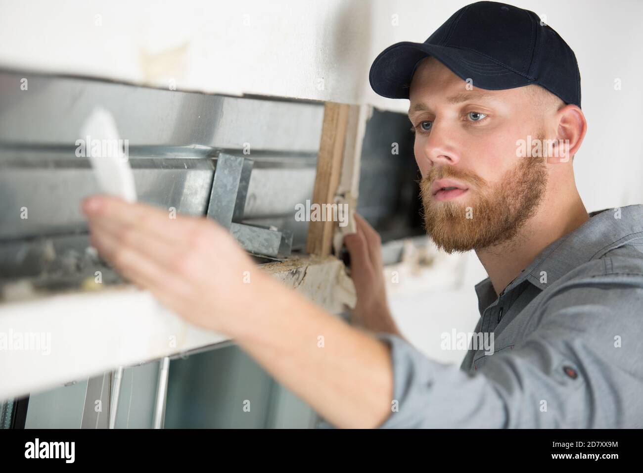 construction worker repairing window in house Stock Photo - Alamy
