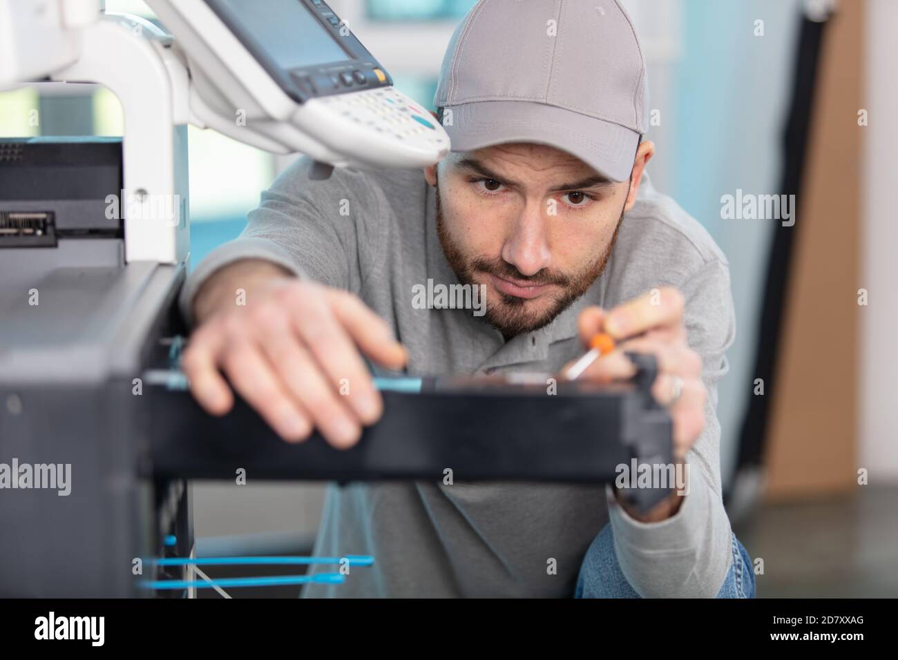 man technician repairing a printer at business place at work Stock ...