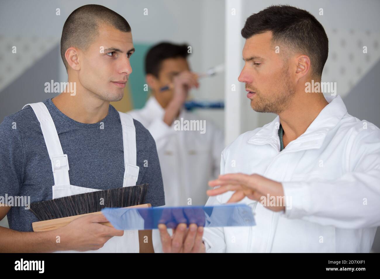 a painter with an apprentice Stock Photo - Alamy