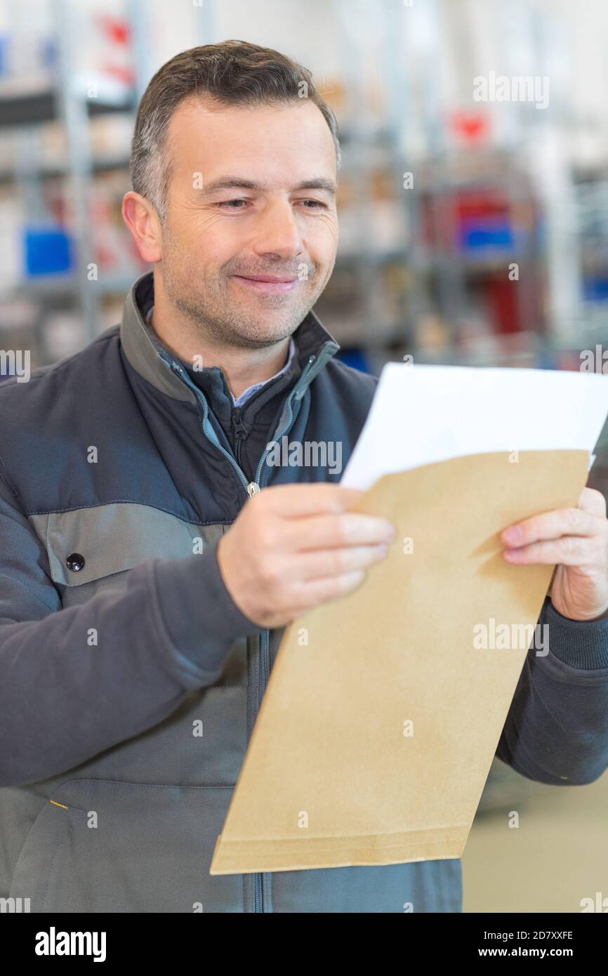 man working in postal parcel delivery service office Stock Photo - Alamy