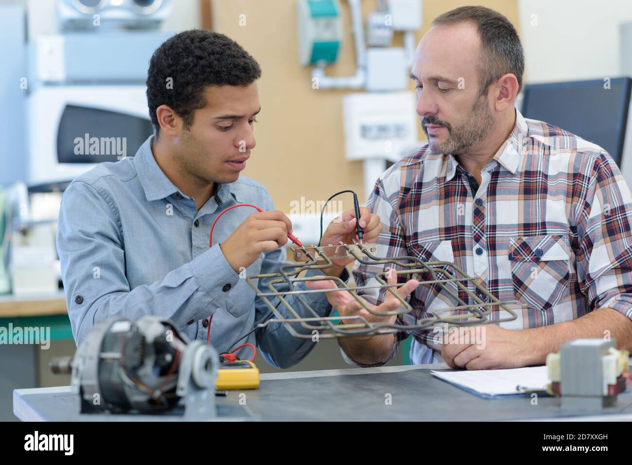 men using multimeter to test heating element Stock Photo - Alamy