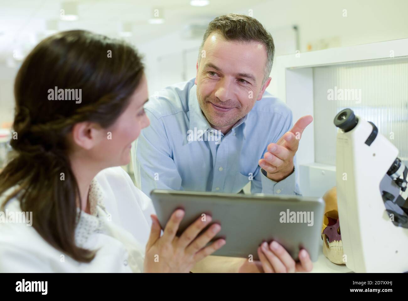 group of scientific workers taking notes making research in laboratory ...