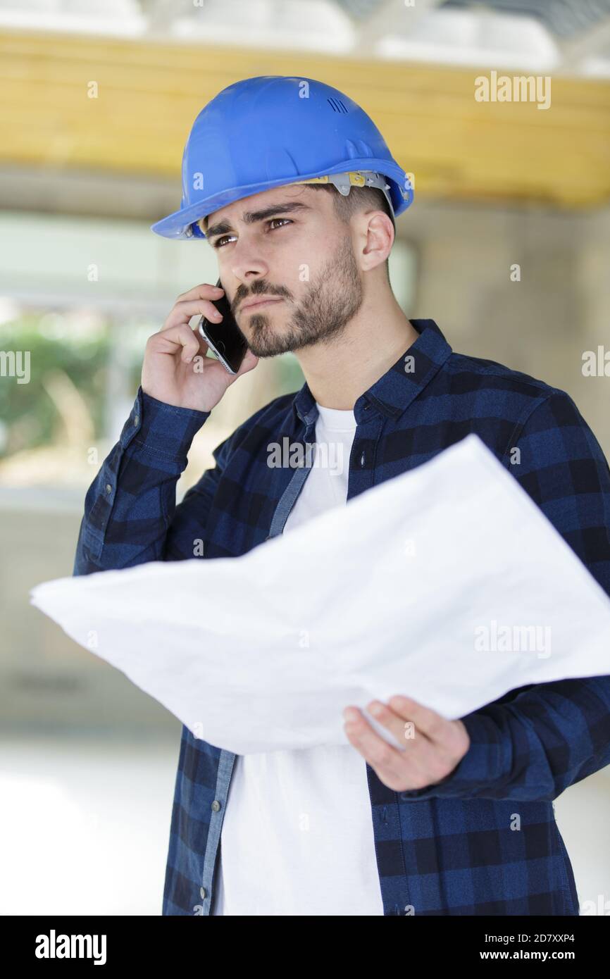 architect checking a house project and having a phone call Stock Photo ...