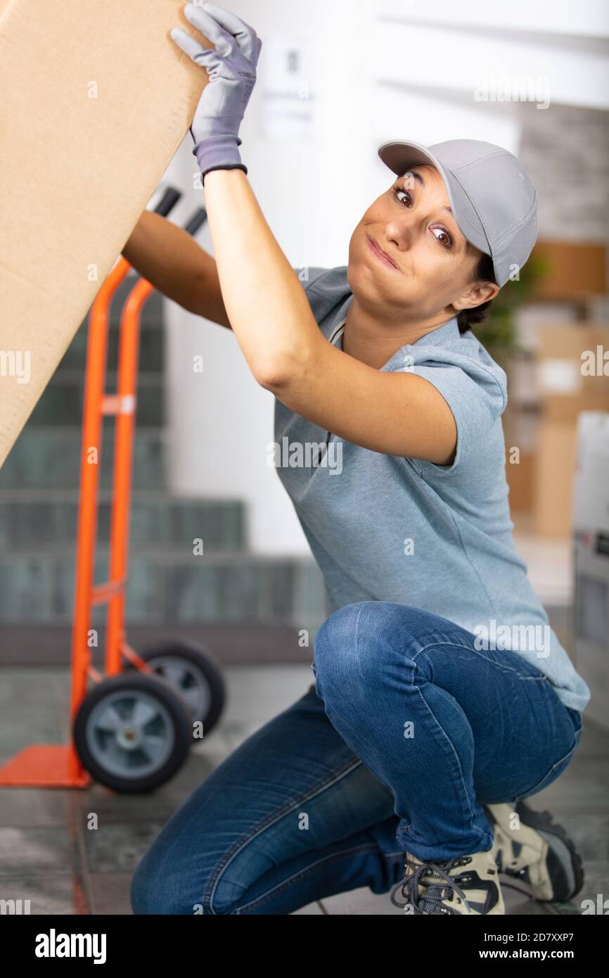 deliverywoman struggling with a pile of parcels Stock Photo - Alamy