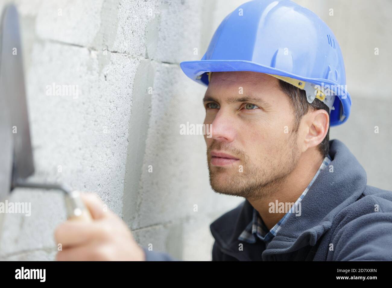 male builder working with cement block Stock Photo - Alamy