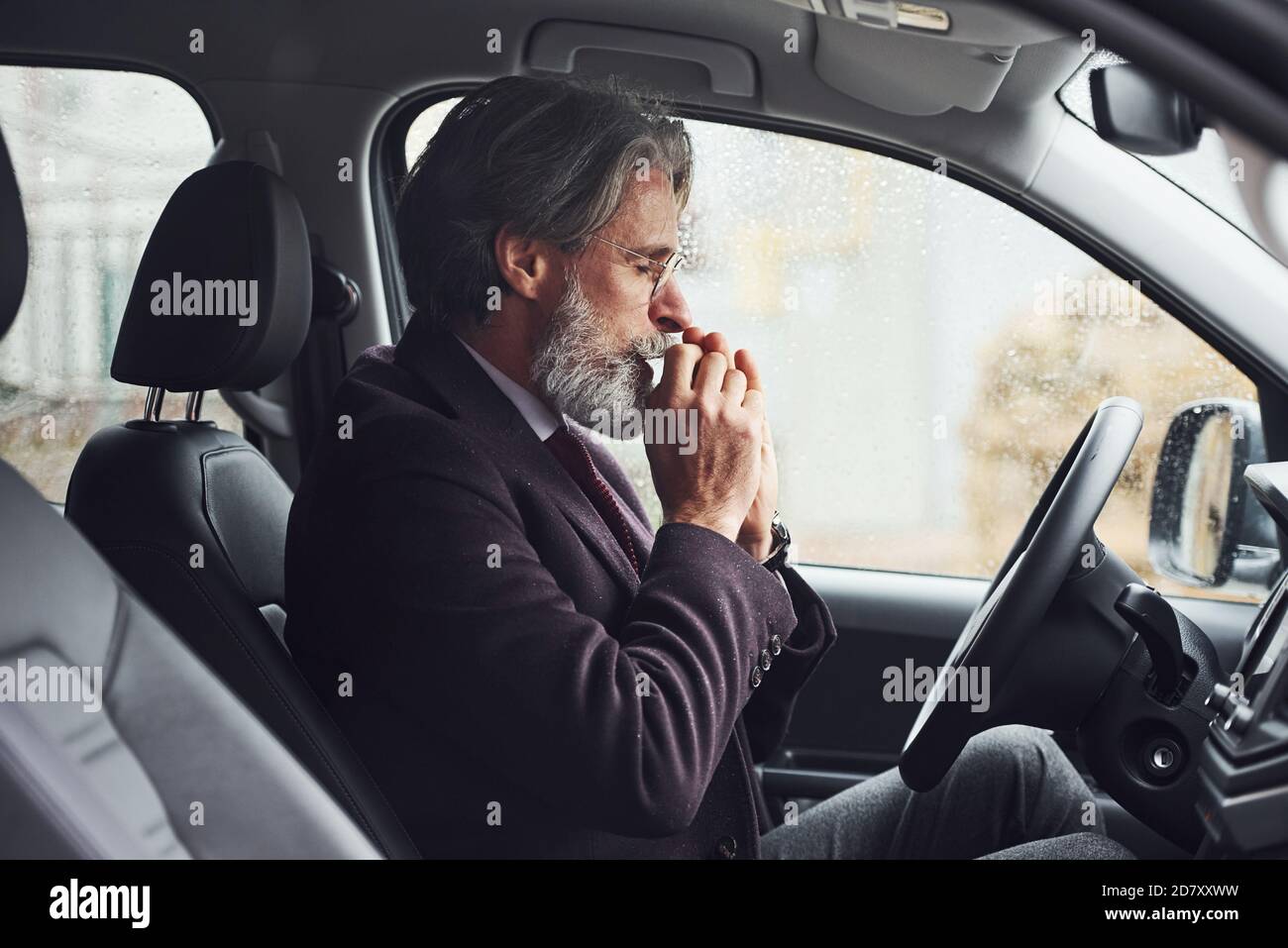 Fashionable senior man in elegant clothes is in the modern car Stock ...