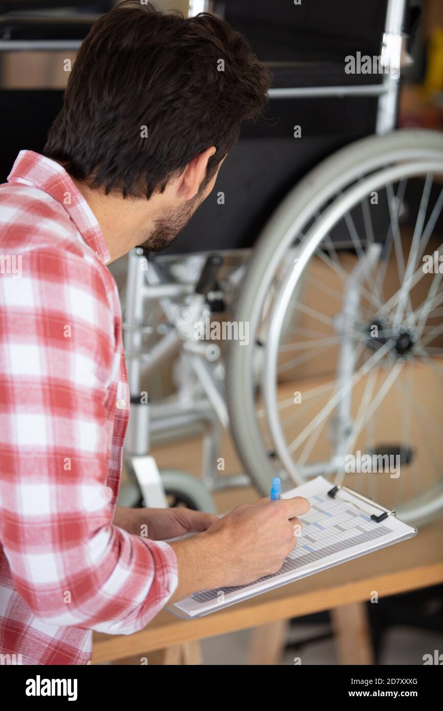 man is fixing a wheelchair Stock Photo - Alamy