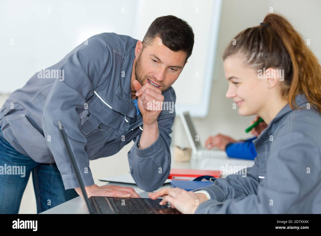 students working on car engine classroom Stock Photo - Alamy