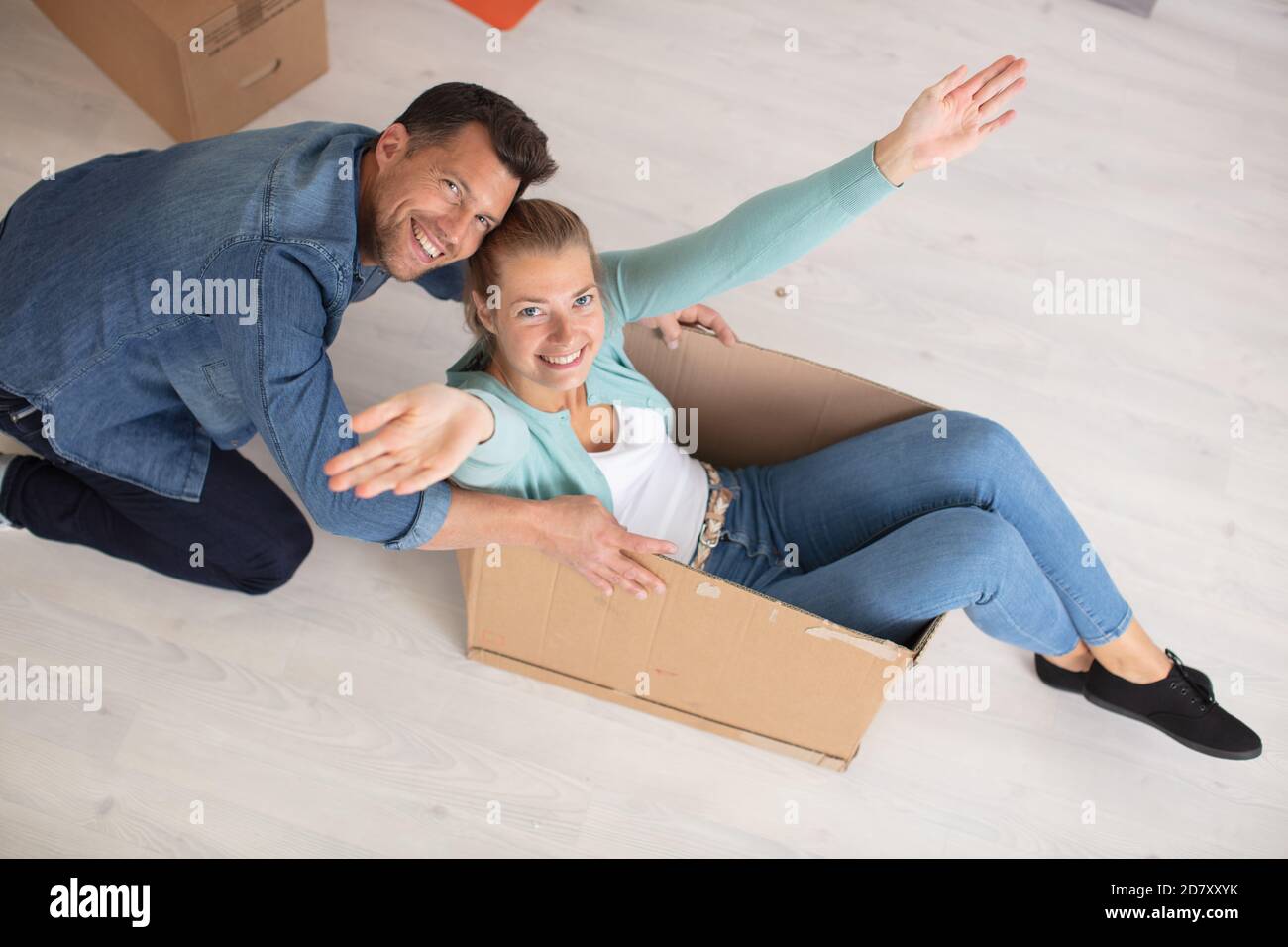 happy family moving boxes in their new home Stock Photo - Alamy
