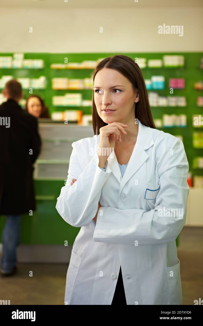 Thoughtful pharmacist stands in a pharmacy Stock Photo - Alamy