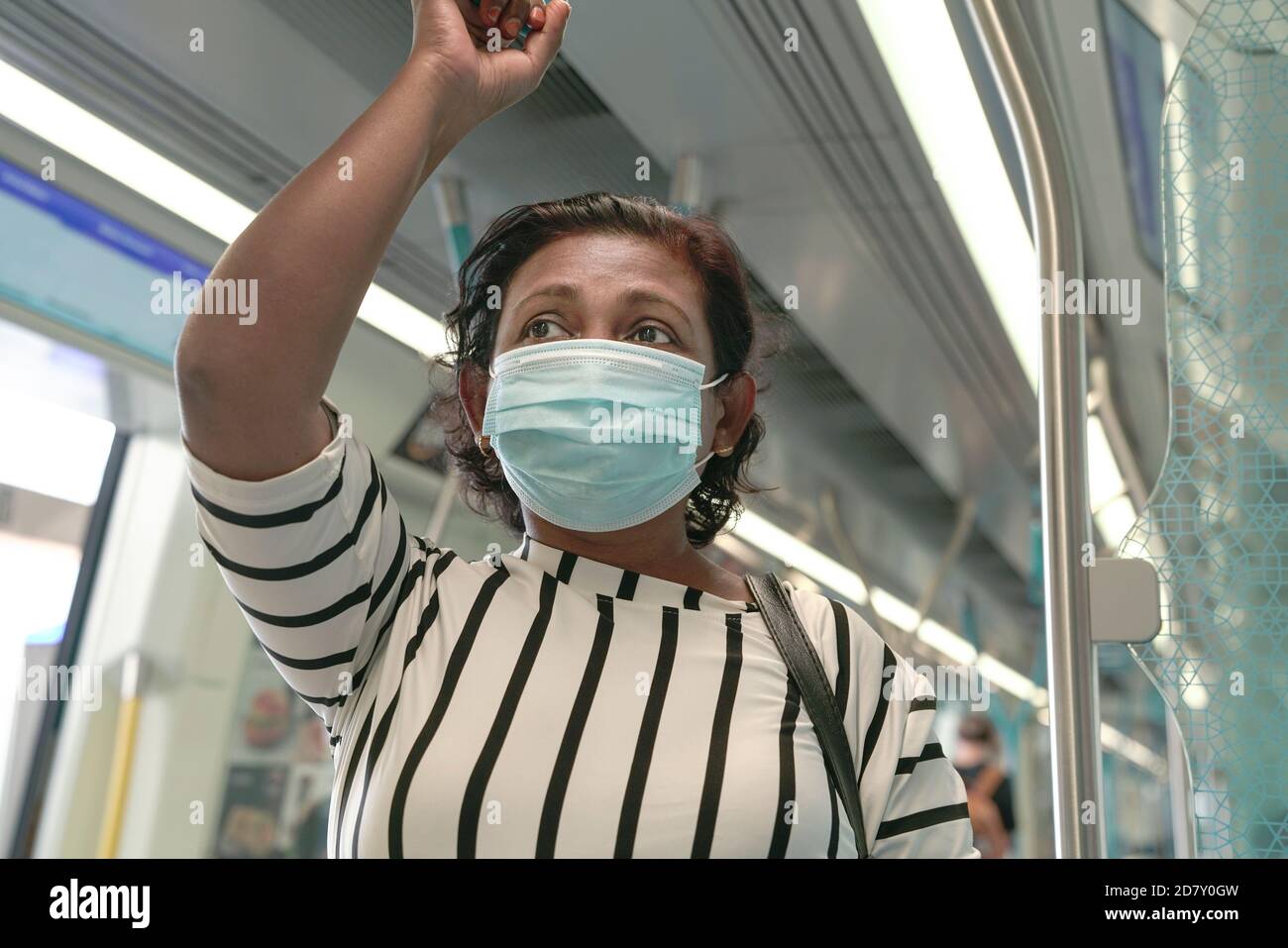 Woman commuter wearing face mask inside train. Travel new normal during ...